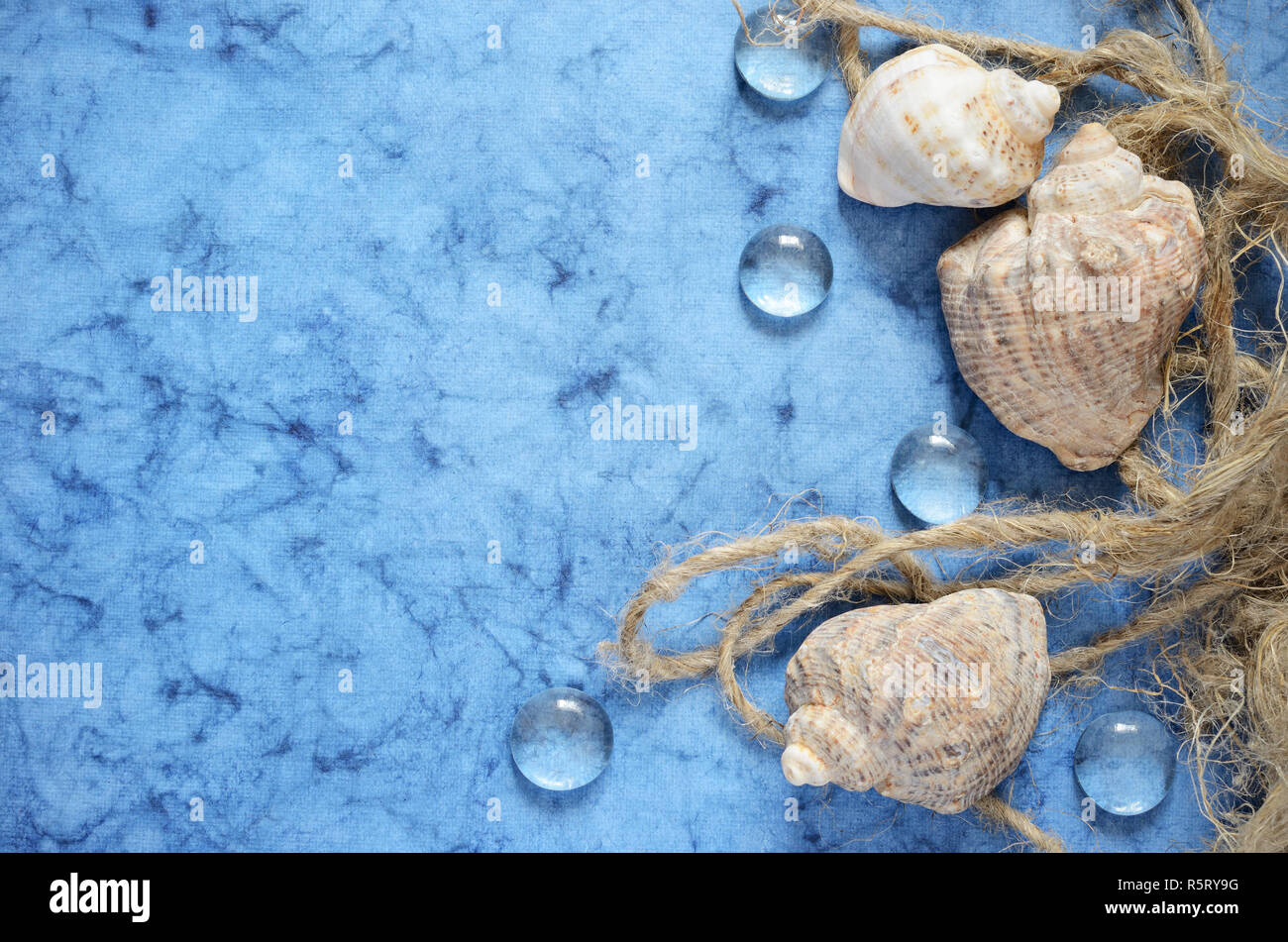Blue sea background with shells and a rope Stock Photo - Alamy