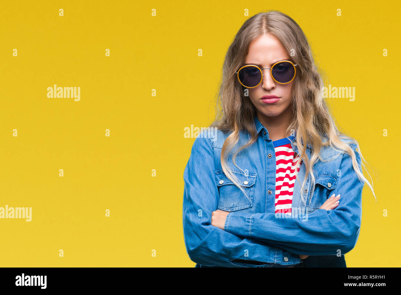 Beautiful young blonde woman wearing sunglasses over isolated ...