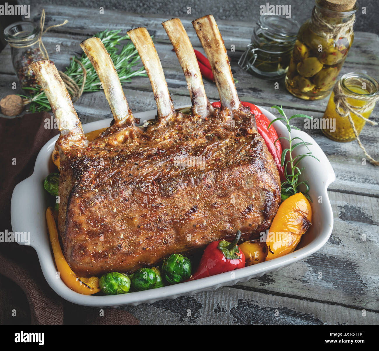 Grilled roasted rack of veal lamb chops with vegetables in ceramic ...