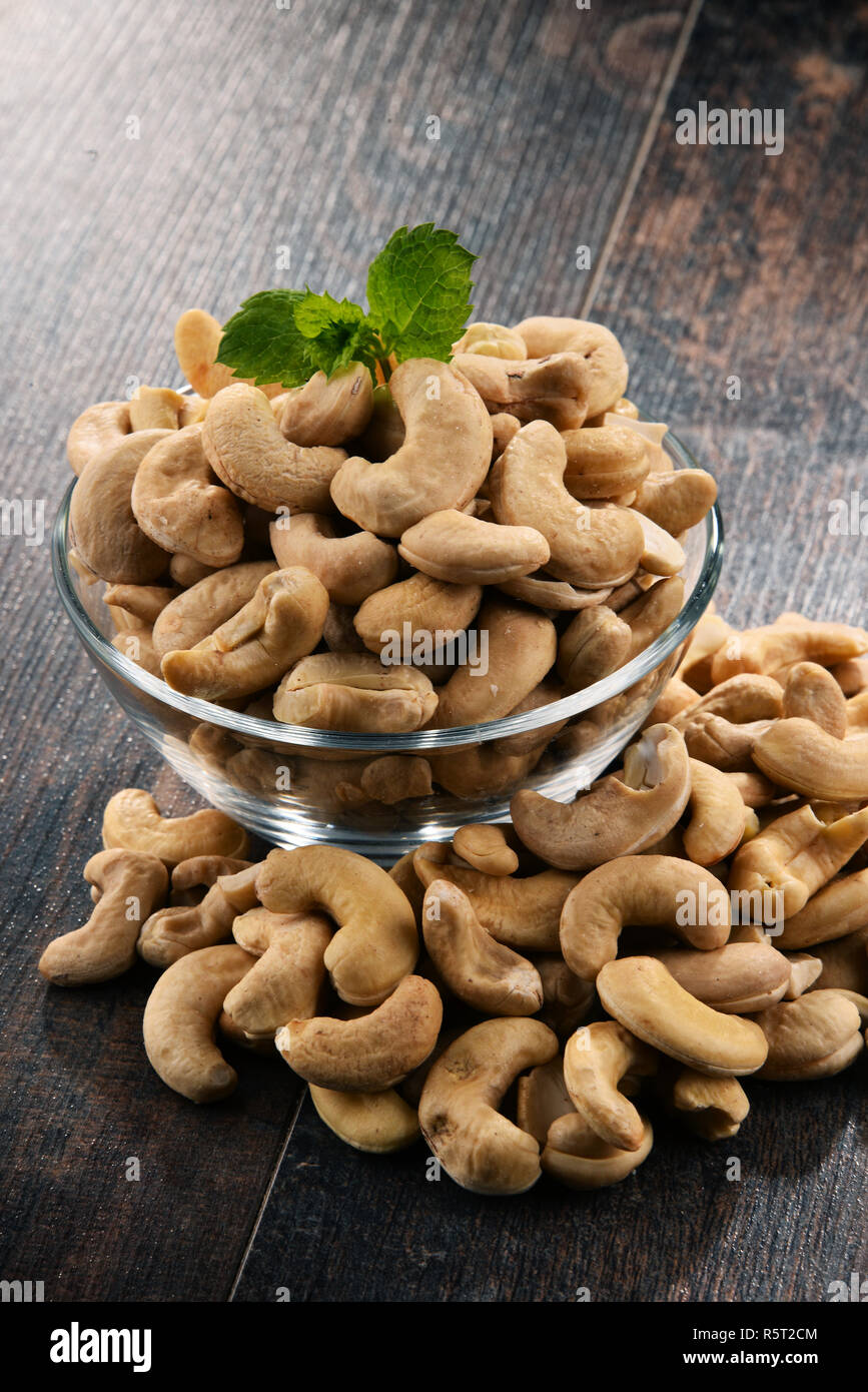 Bowl with cashew nuts on wooden table Stock Photo - Alamy