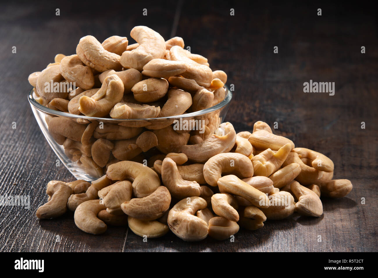 Bowl with cashew nuts on wooden table Stock Photo - Alamy