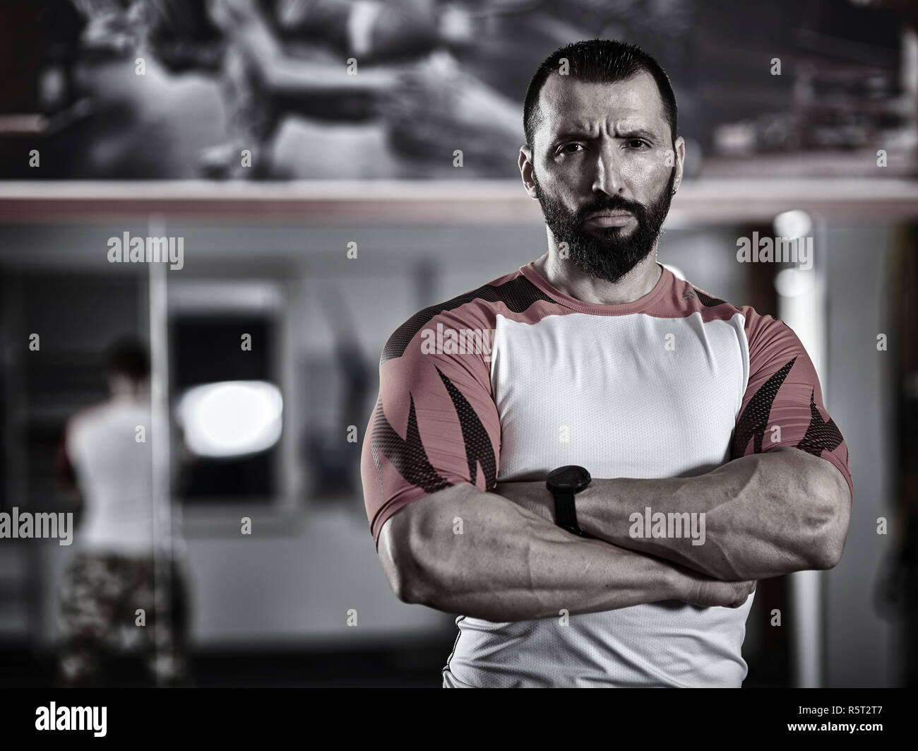 Confident and motivated fitness coach posing in the gym Stock Photo - Alamy
