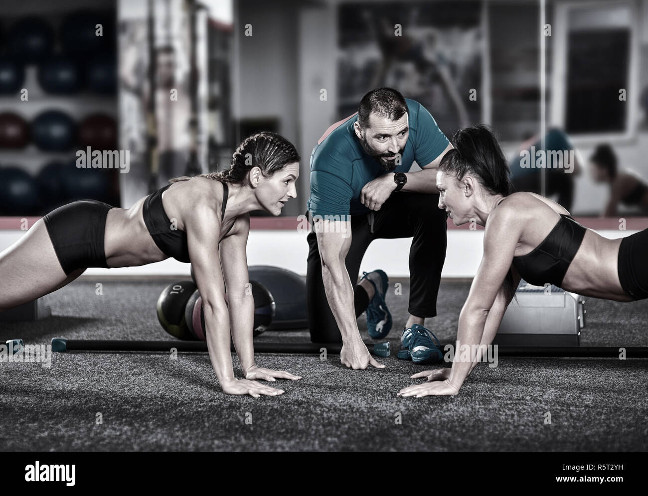 Fitness trainer and girls doing crossfit workout in the gym Stock Photo ...