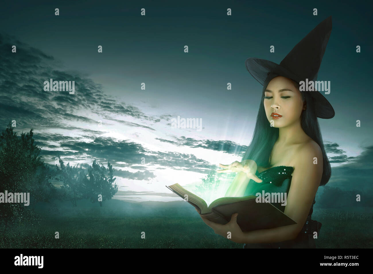 Dark asian witch woman with spell book Stock Photo - Alamy