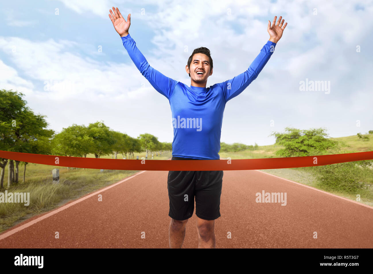 Portrait of asian man running crossing the finish line Stock Photo - Alamy