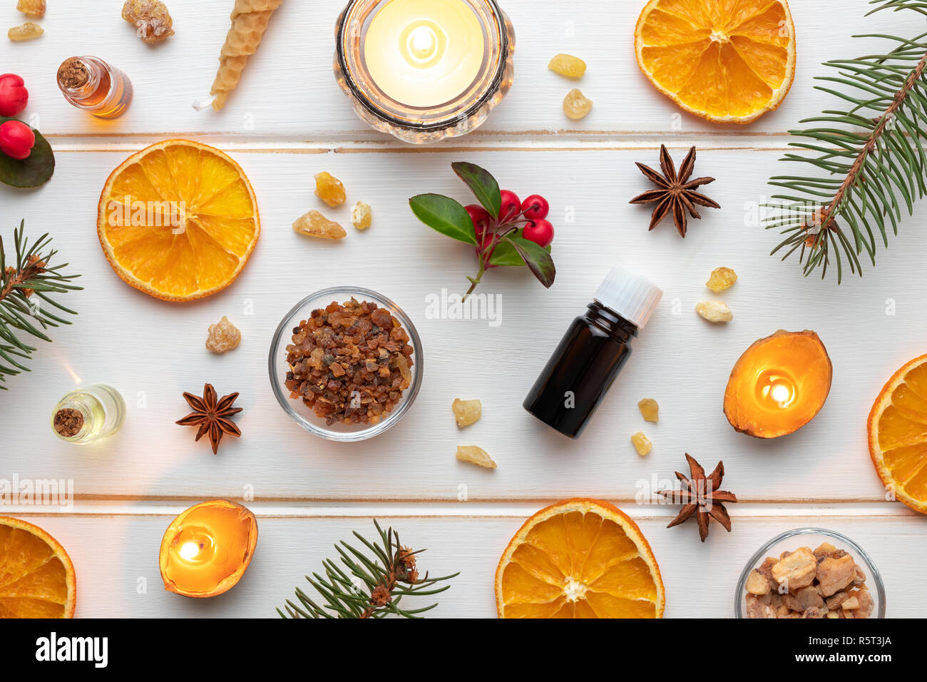 Bottles of essential oil on a white Christmas background with ...