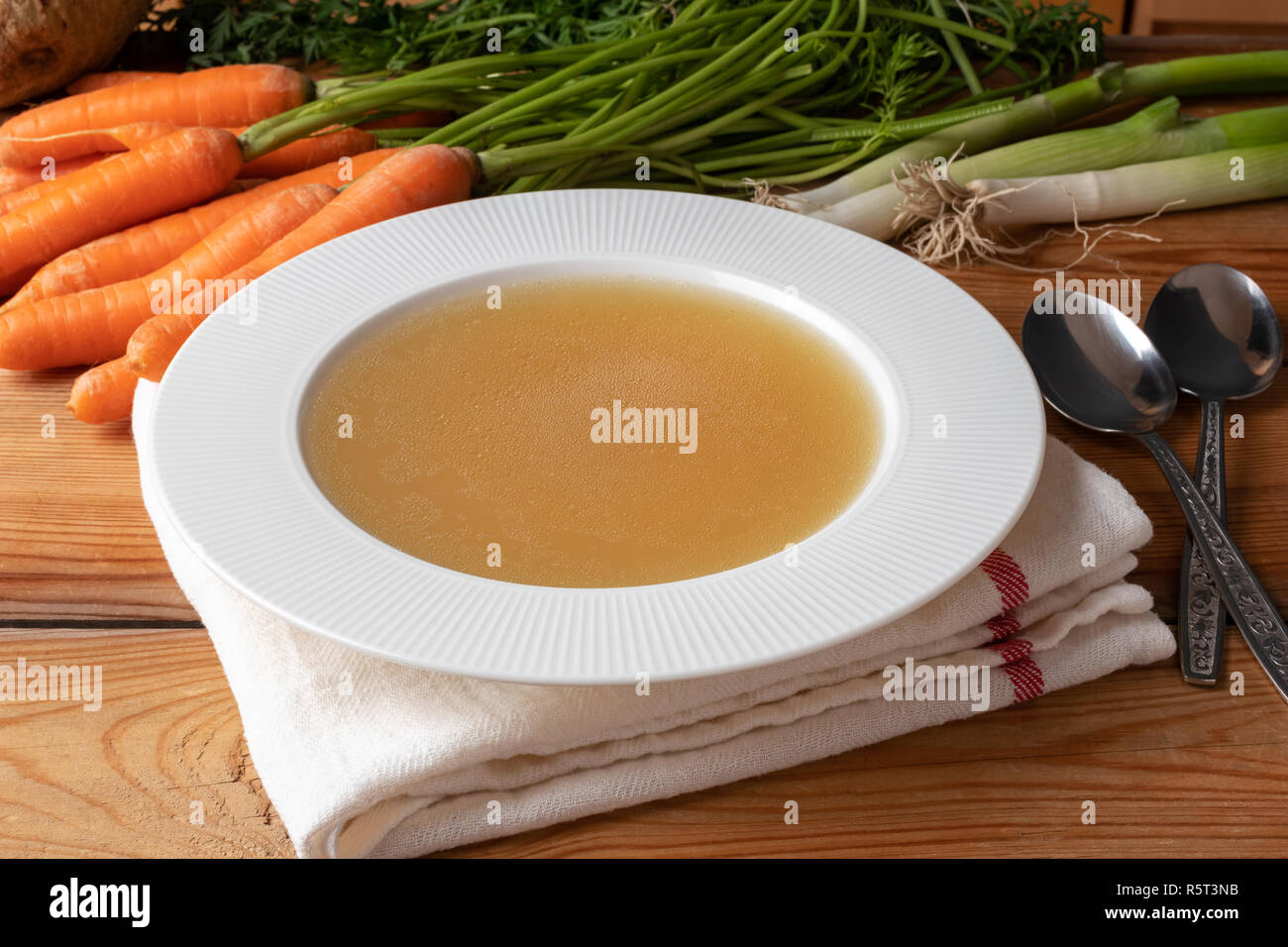 Chicken bone broth with fresh vegetables Stock Photo - Alamy