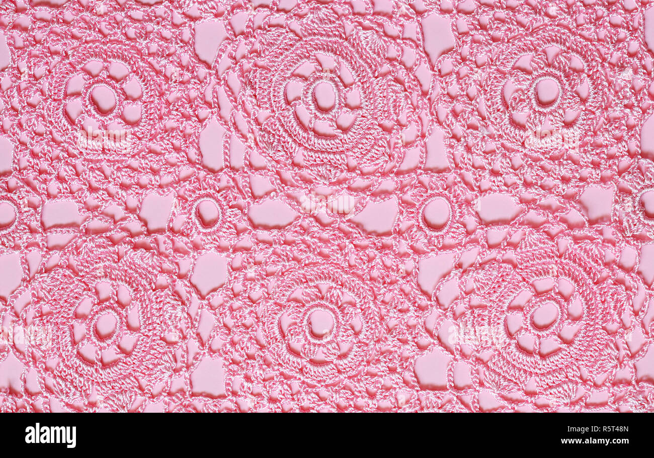 Pink crochet lace on a pink background Stock Photo - Alamy