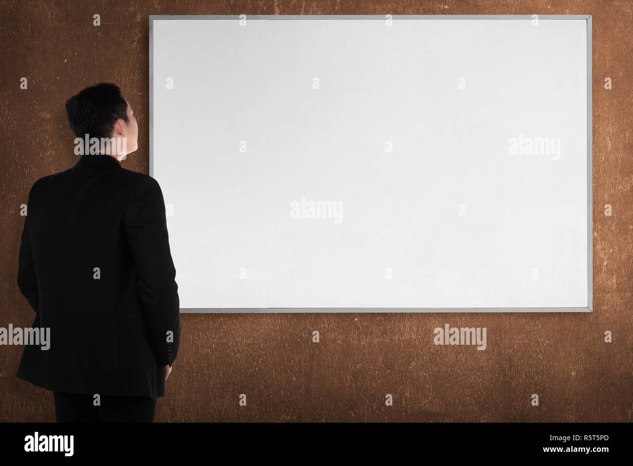 Back view young man with white board Stock Photo - Alamy