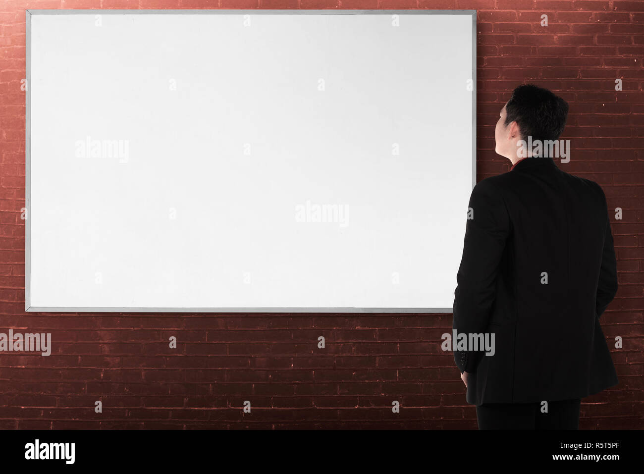 Back view young man with white board Stock Photo - Alamy