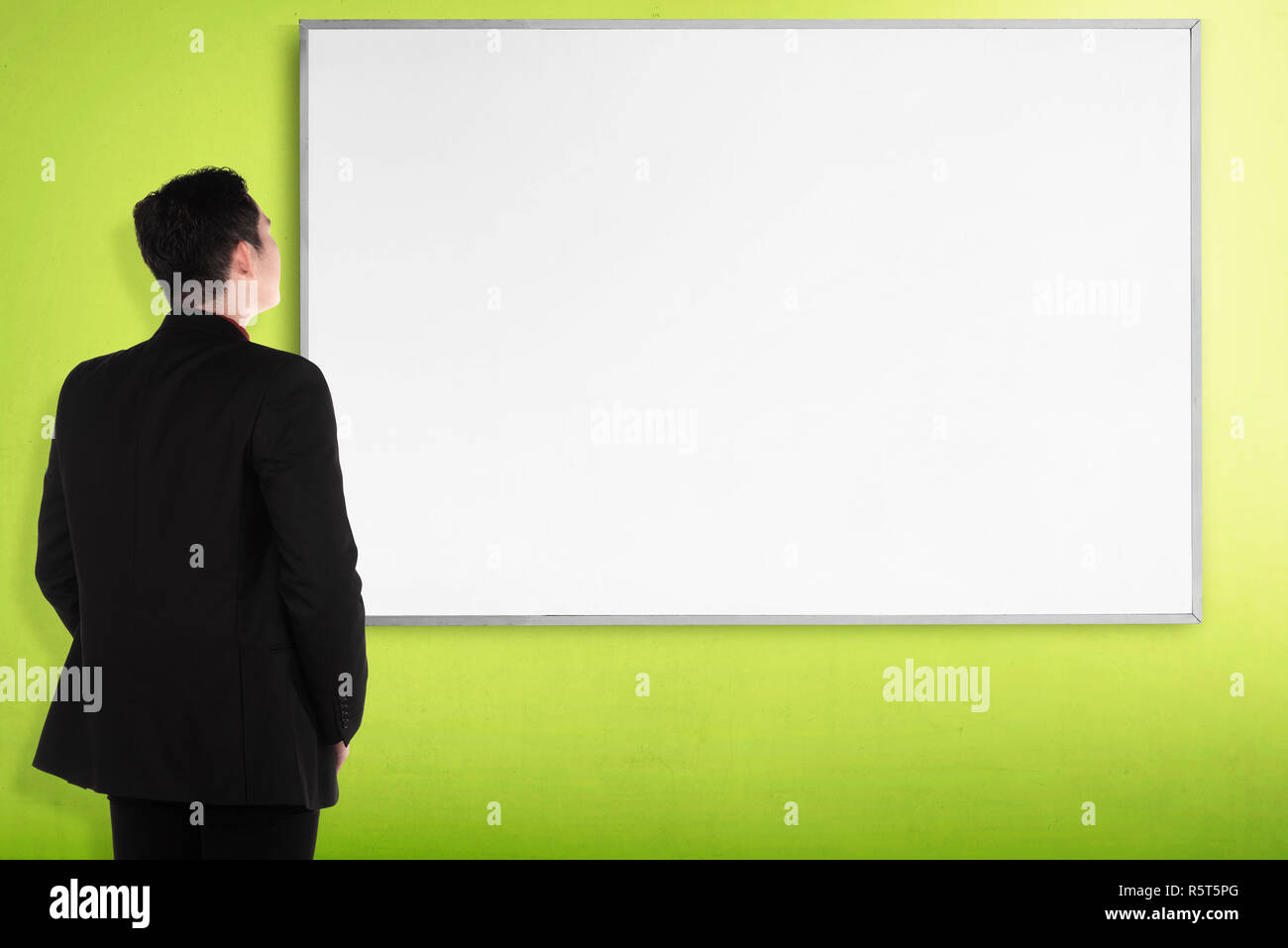 Back view young man with white board Stock Photo - Alamy