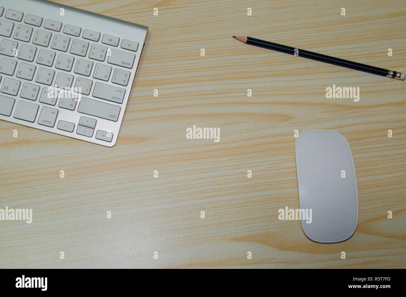 office table Keyboard, mouse, and pencil on wood background Stock Photo ...