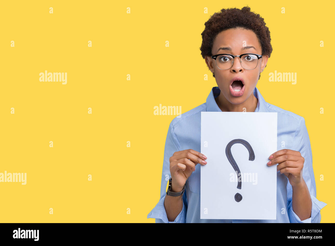 Young african american woman holding paper with question mark over ...