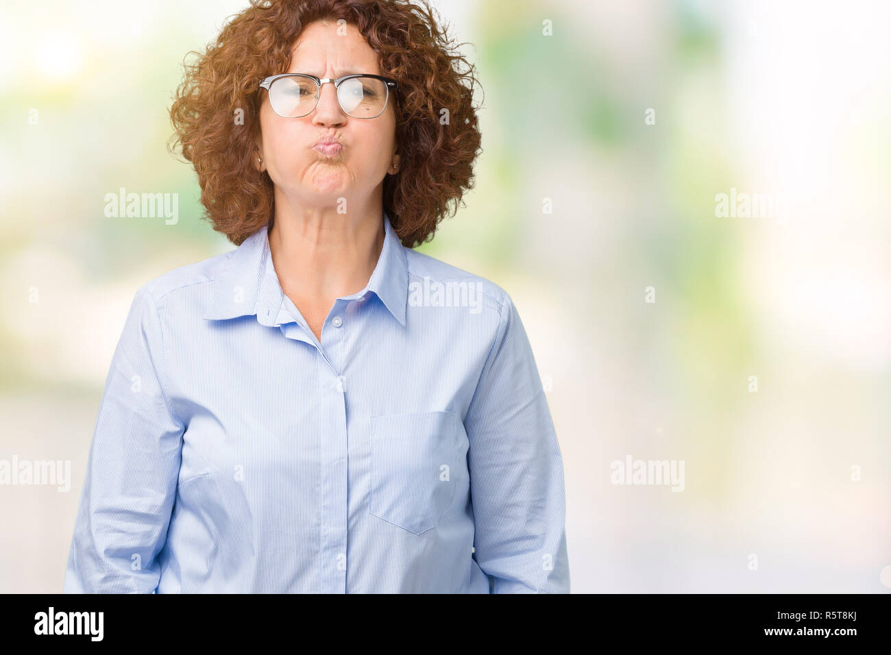 Beautiful middle ager senior businees woman wearing glasses over ...