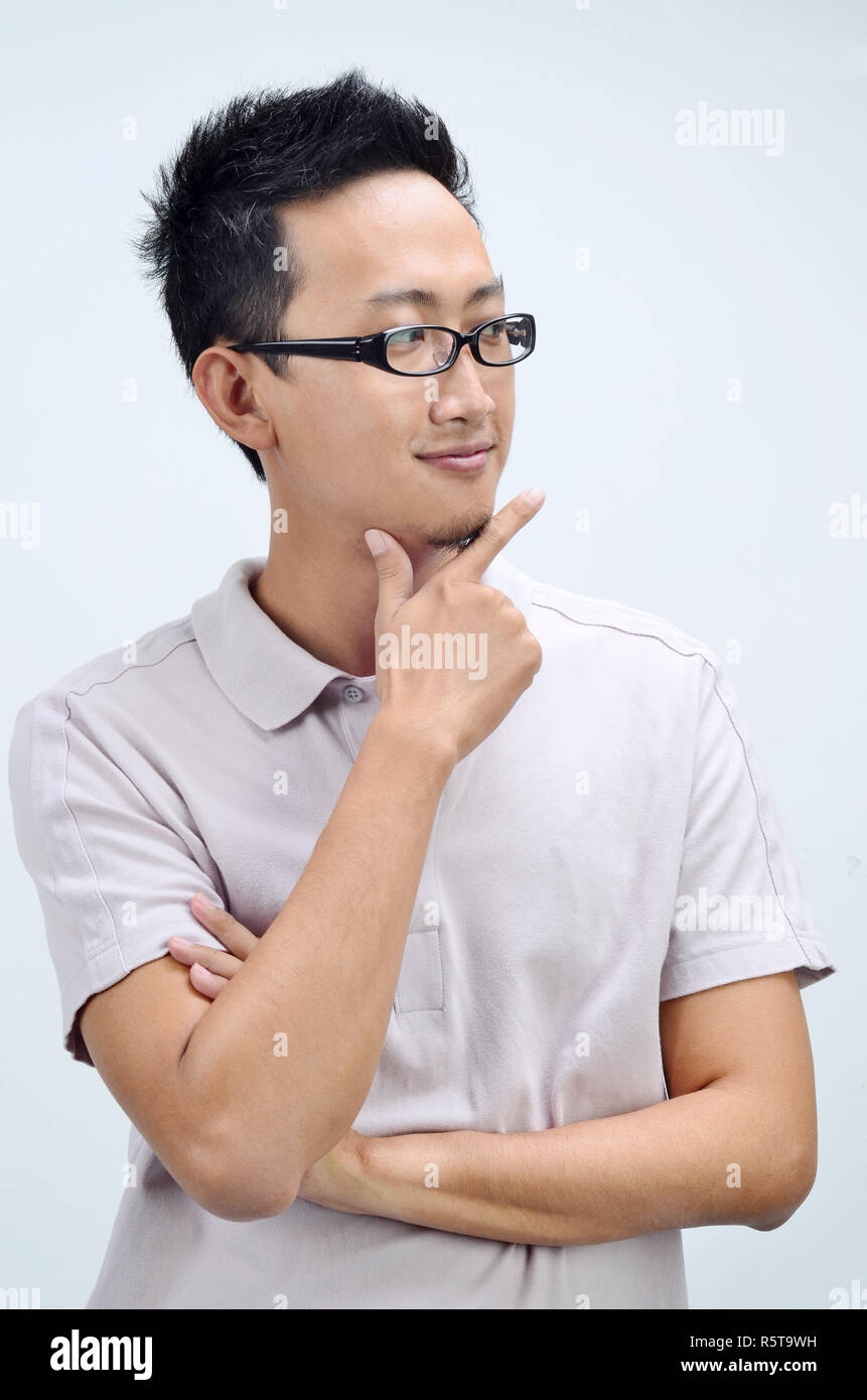 Casual Asian man thinking Stock Photo - Alamy