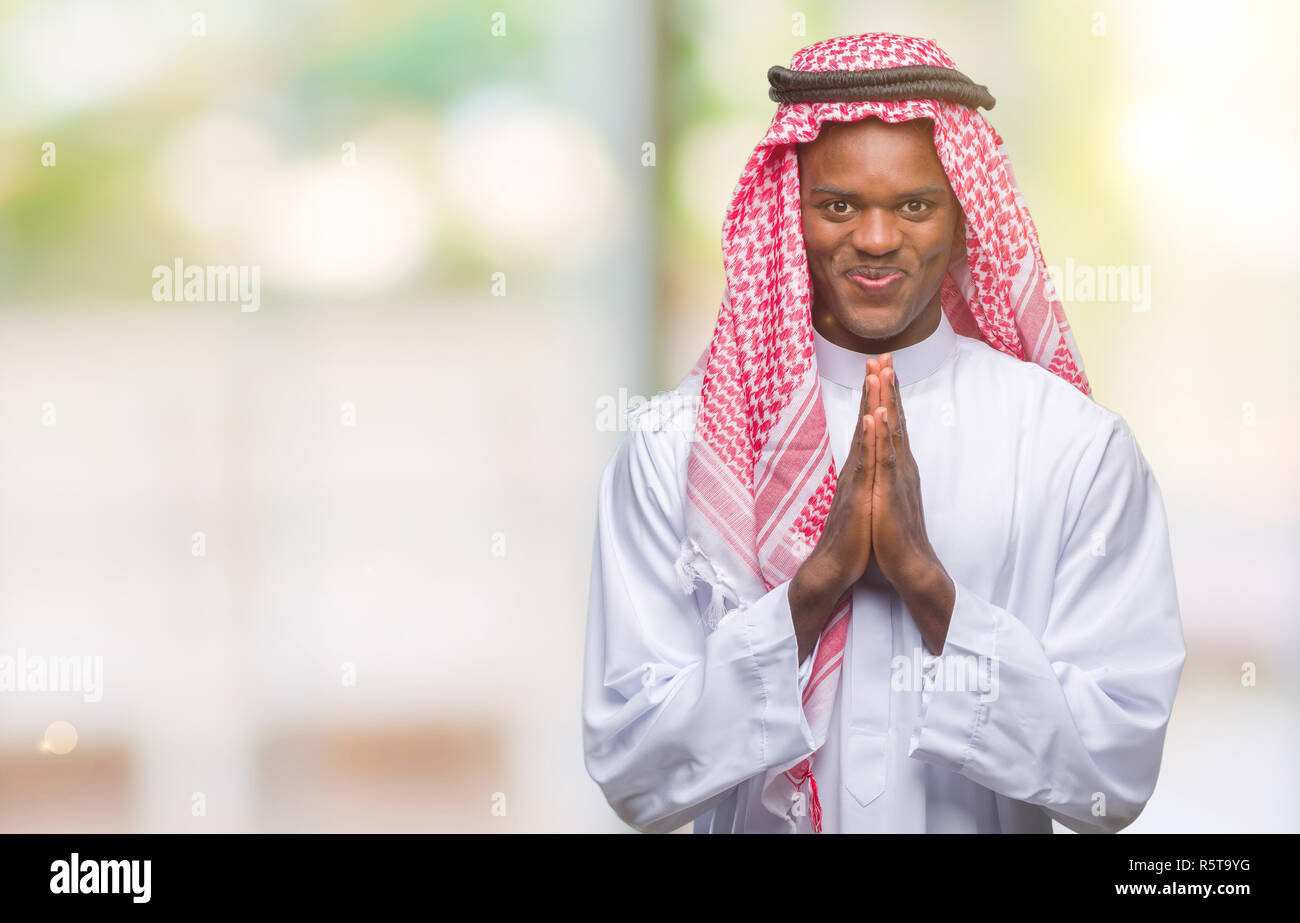 Young arabic african man wearing traditional keffiyeh over isolated ...