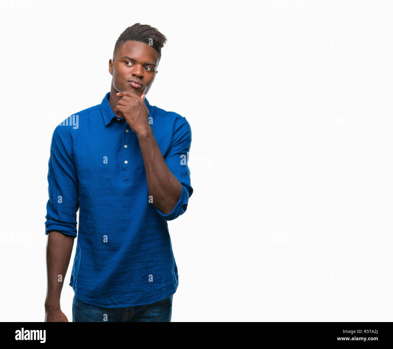 Young african american man over isolated background with hand on chin ...