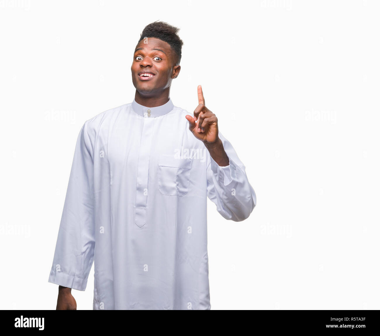Young arabic african man wearing traditional djellaba over isolated ...