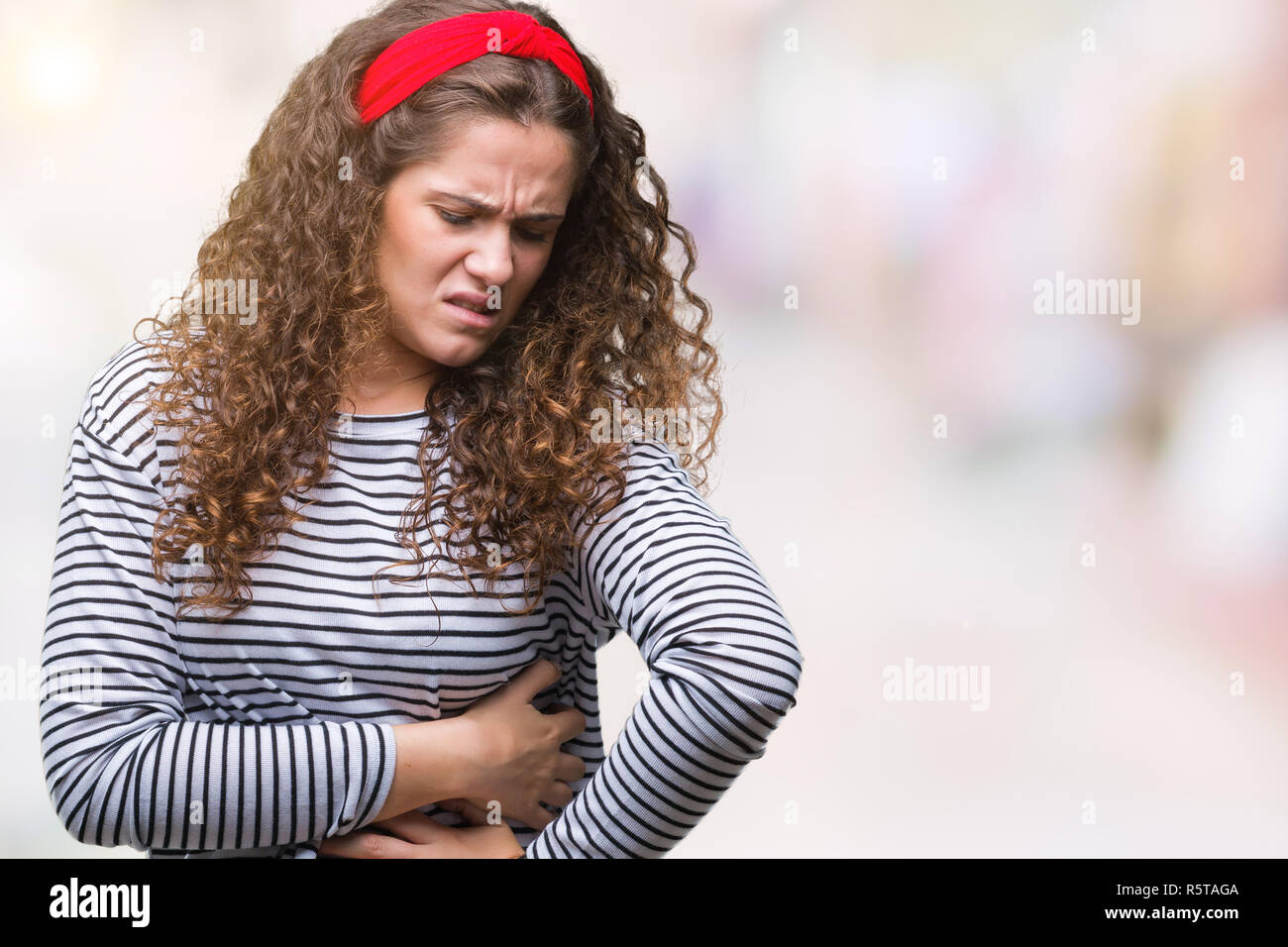 Beautiful brunette curly hair young girl wearing stripes sweater over ...