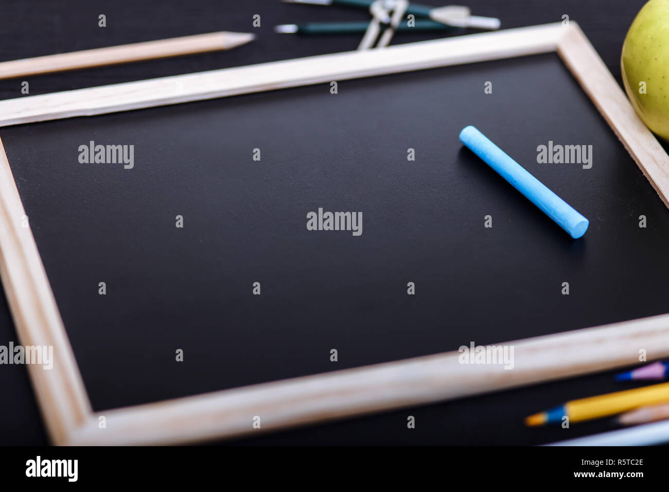 Back to school concept, colored pencils on black table, multicolored ...