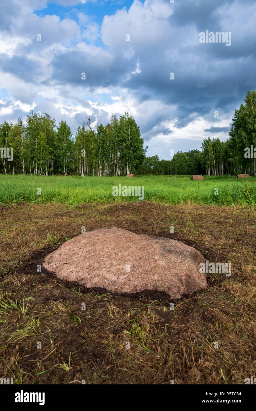 large granite rock single in nature environment isolated from other ...