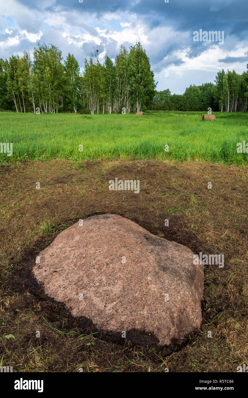 large granite rock single in nature environment isolated from other ...