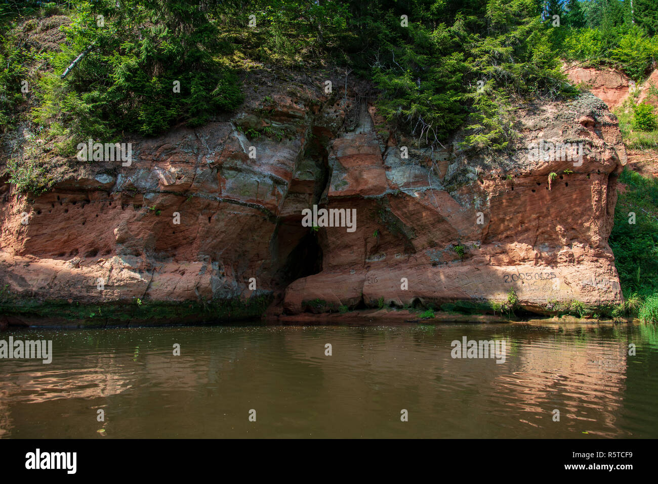 water stream in river of Amata in Latvia with sandstone cliffs, green ...