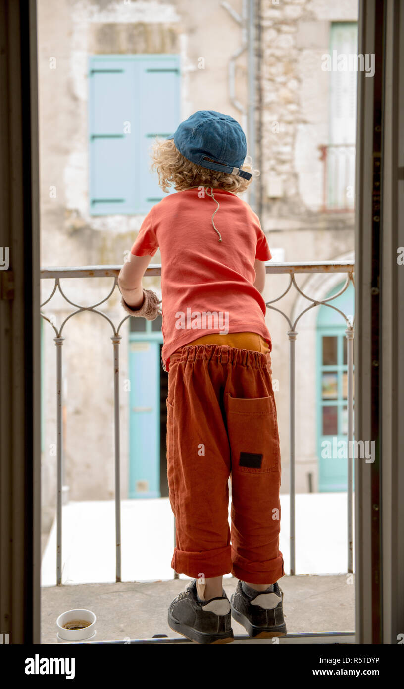little boy looking out the window, back view Stock Photo - Alamy