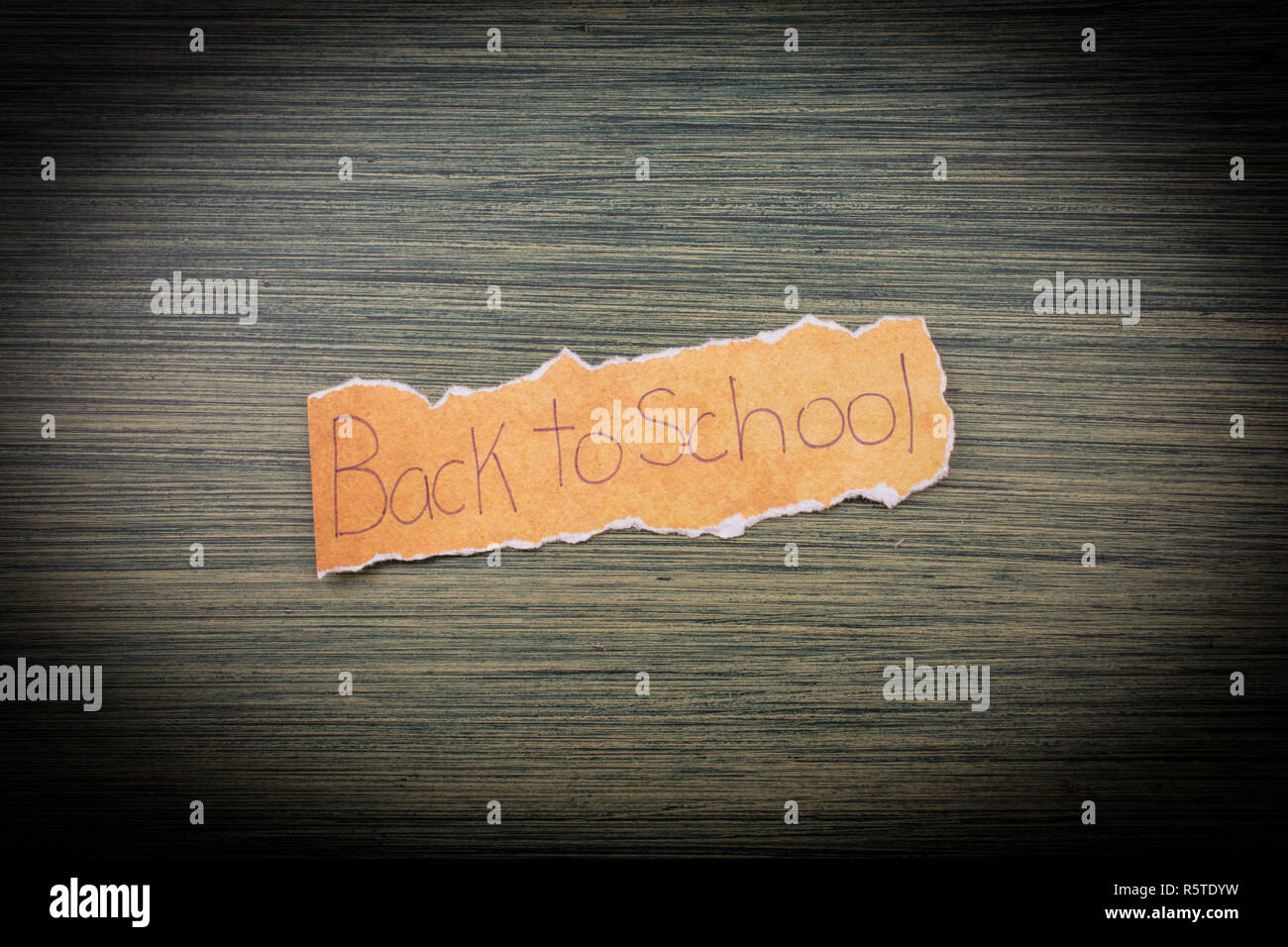 Back to school wording on a piece of torn paper Stock Photo - Alamy