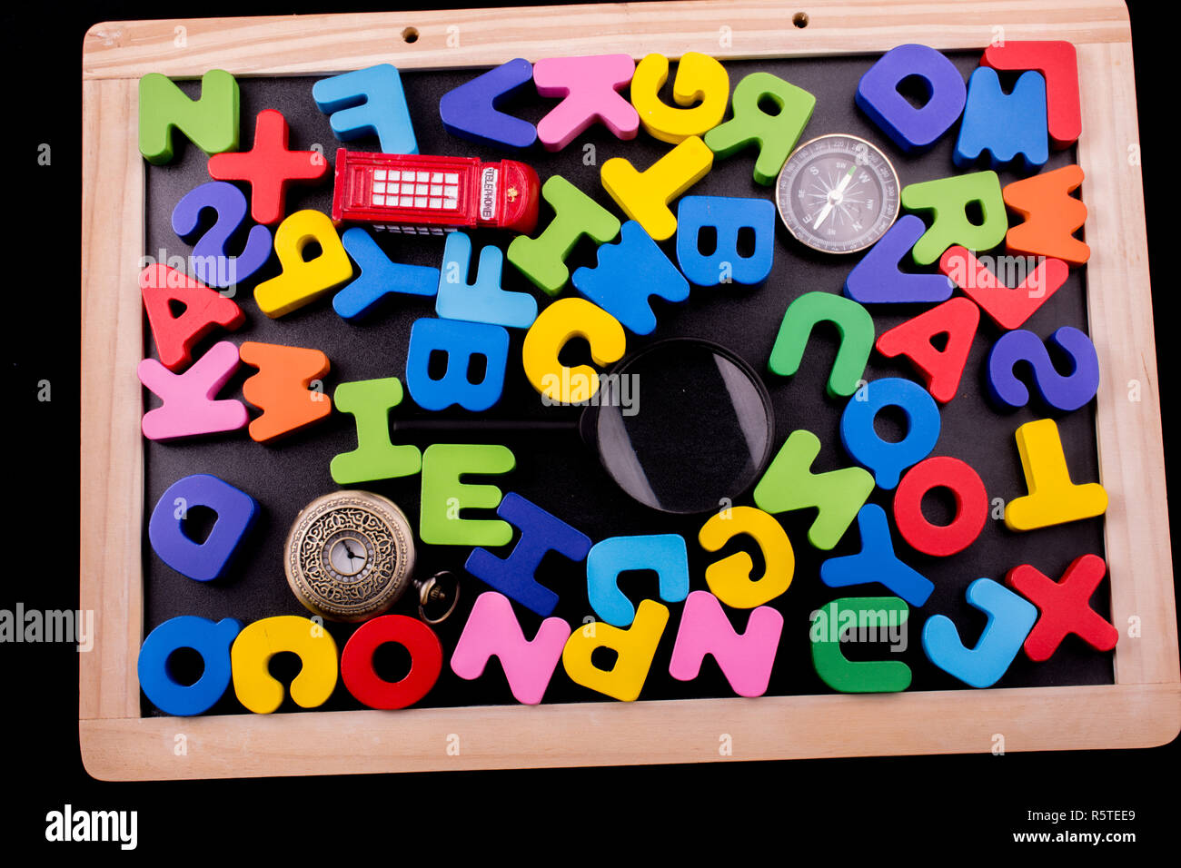 Magnifying glass and Colorful Letters of Alphabet Stock Photo - Alamy