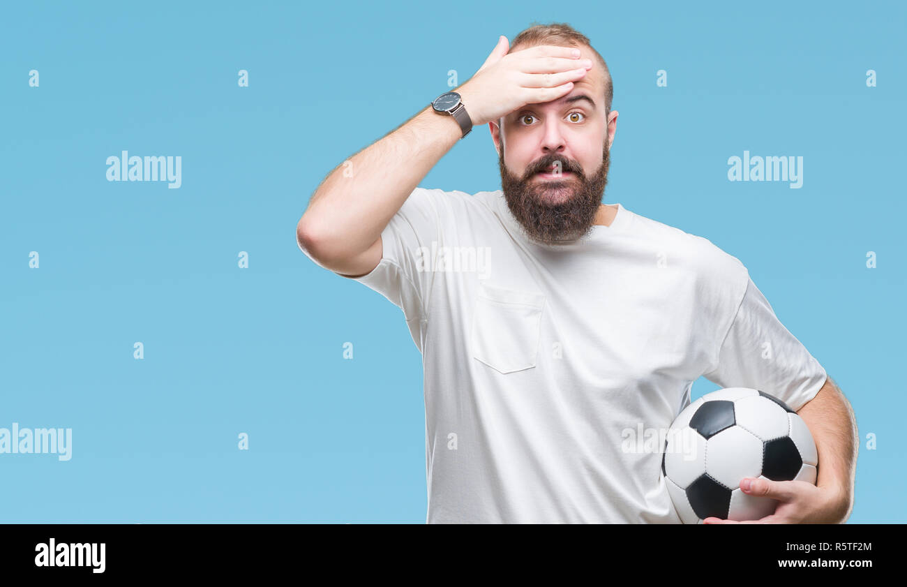 Young caucasian hipster man holding soccer football ball over isolated ...