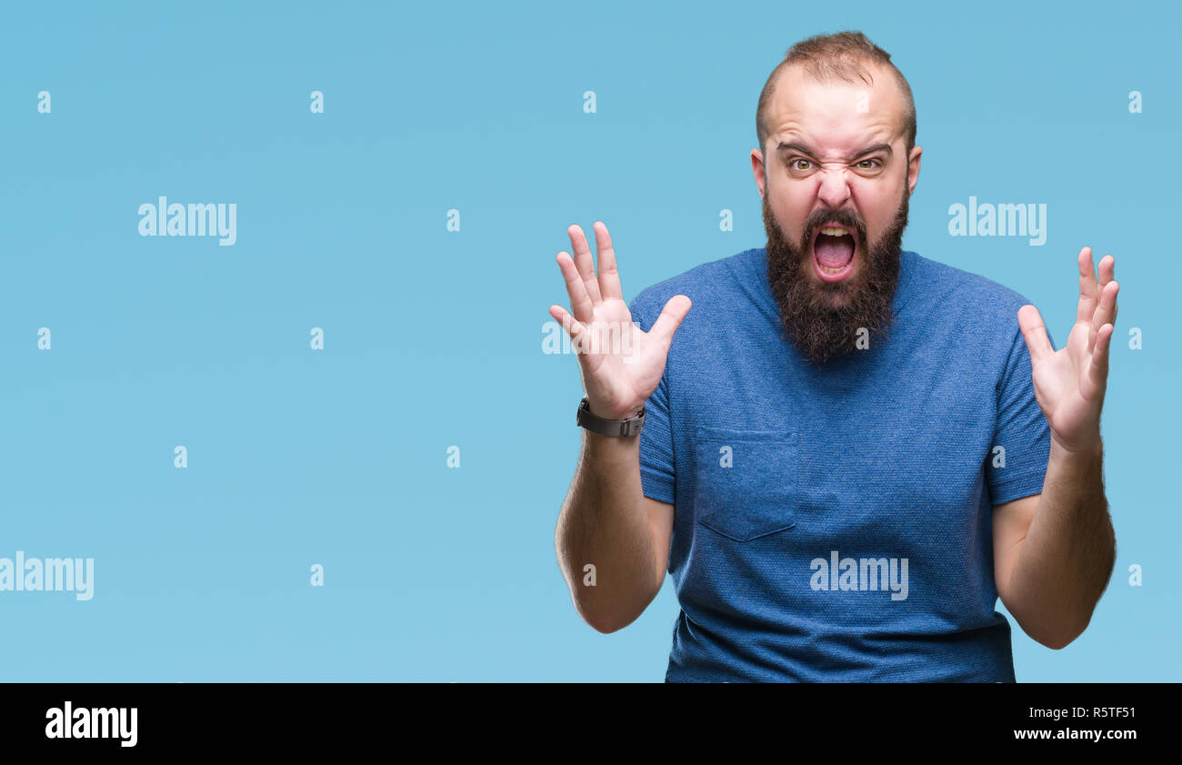 Young caucasian hipster man over isolated background crazy and mad ...