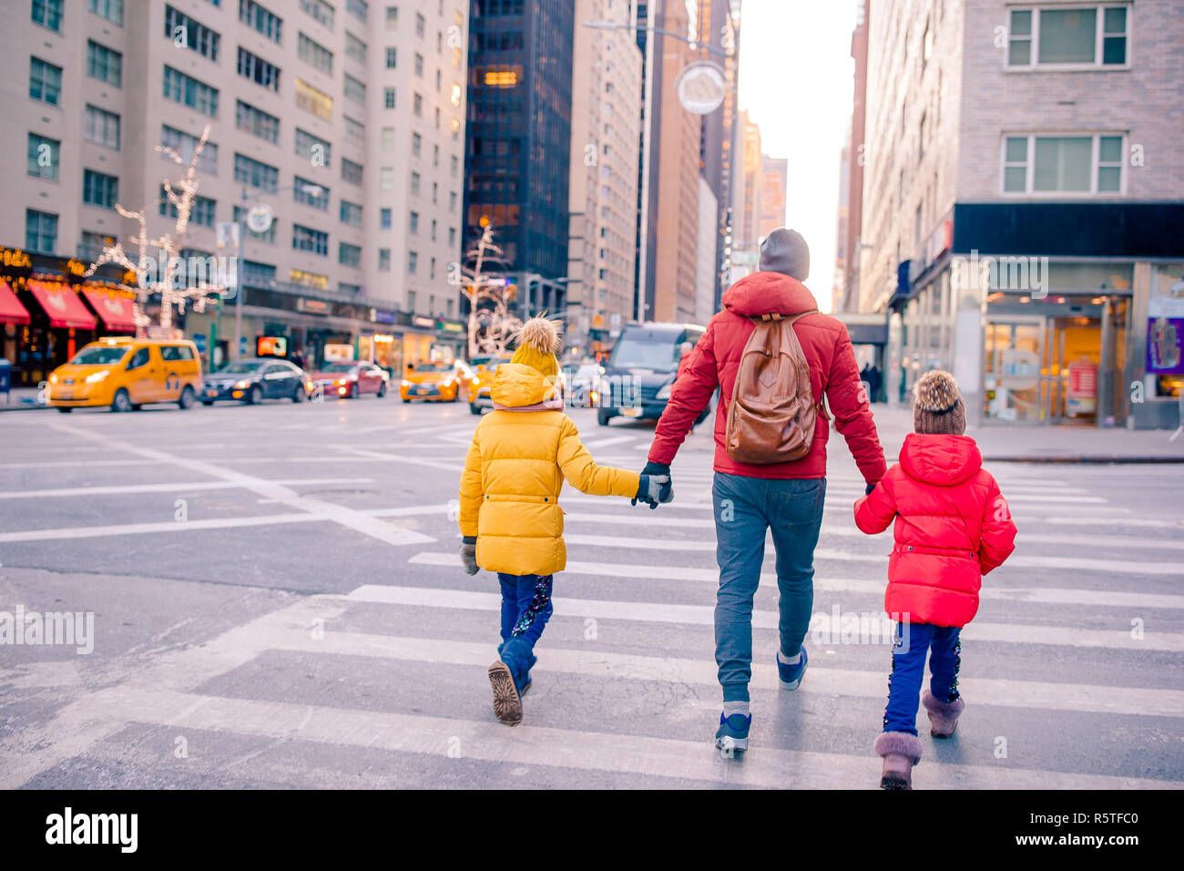 Family of father and little kids on Times Square during their vacation ...