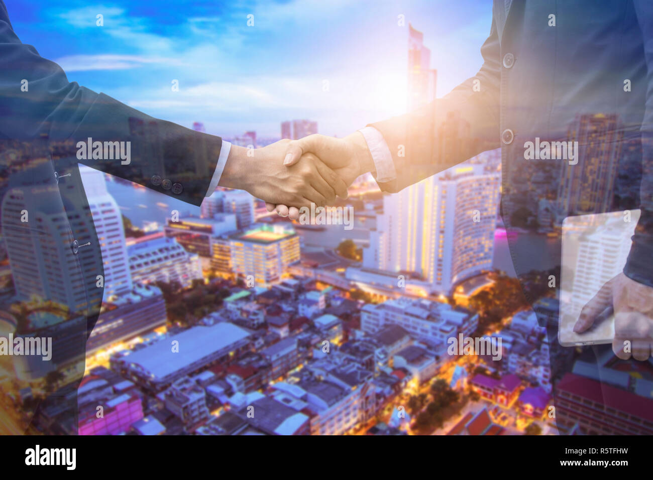double exposure businessman shake hand and night city, handshake of ...