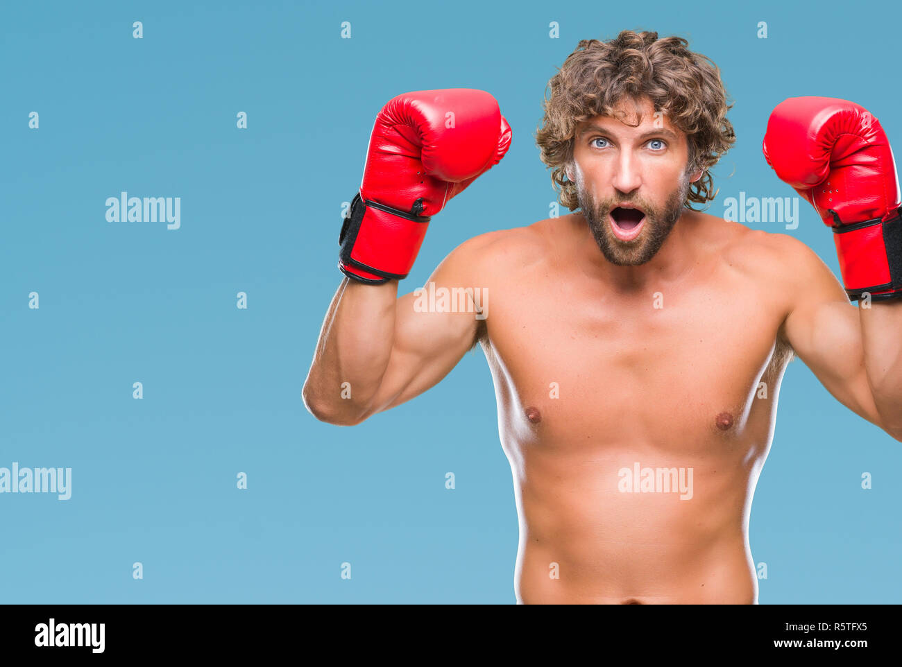 Handsome hispanic boxer man wearing boxing gloves over isolated ...