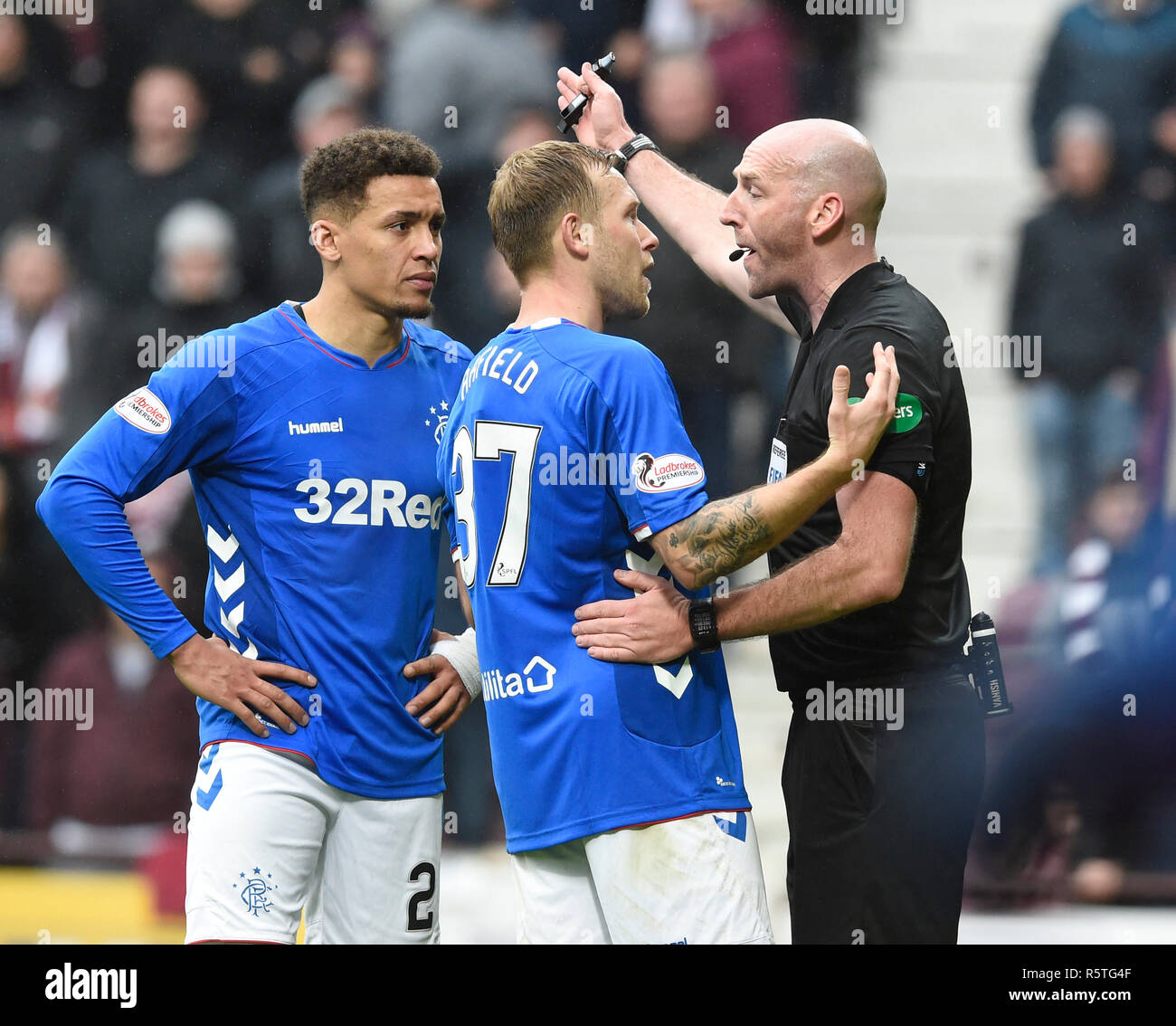Rangers captain James Tavernier looks on as Scott Arfield pleads with ...