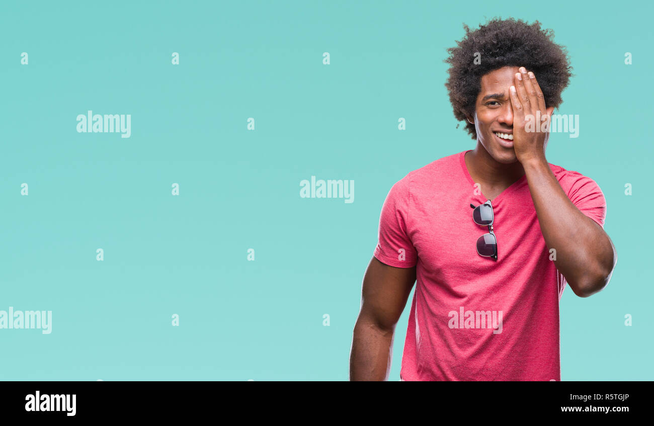 Afro american man over isolated background covering one eye with hand ...