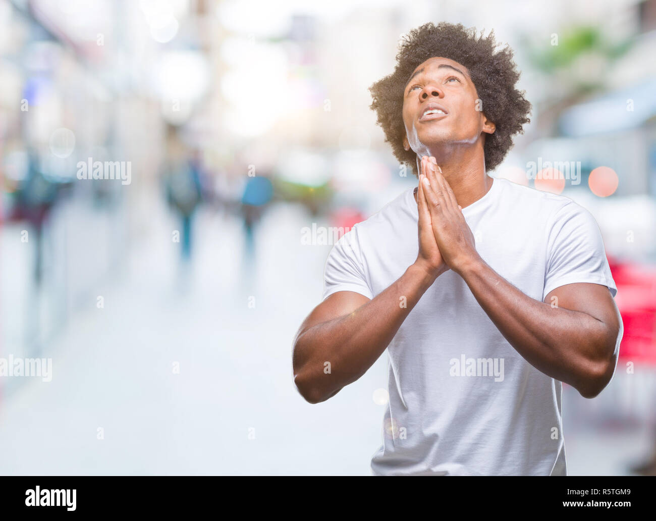 Afro american man over isolated background begging and praying with ...