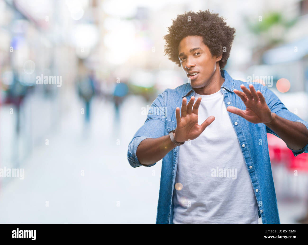 Afro american man over isolated background afraid and terrified with ...