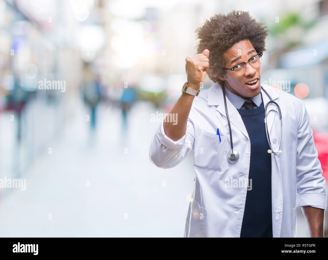 Afro american doctor man over isolated background angry and mad raising ...
