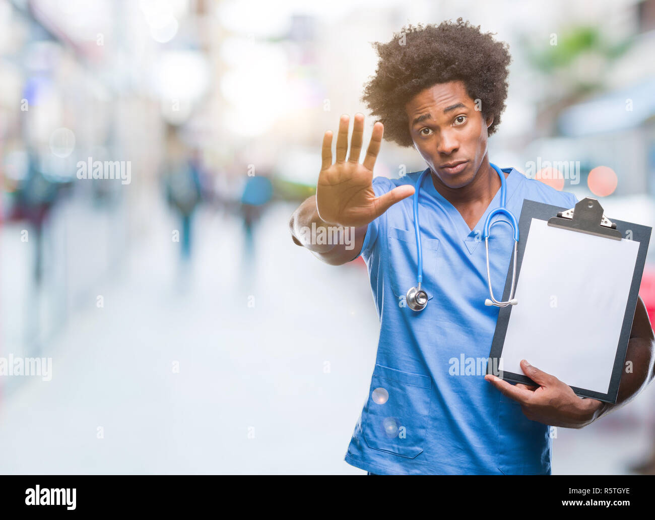 Afro american surgeon doctor holding clipboard man over isolated ...