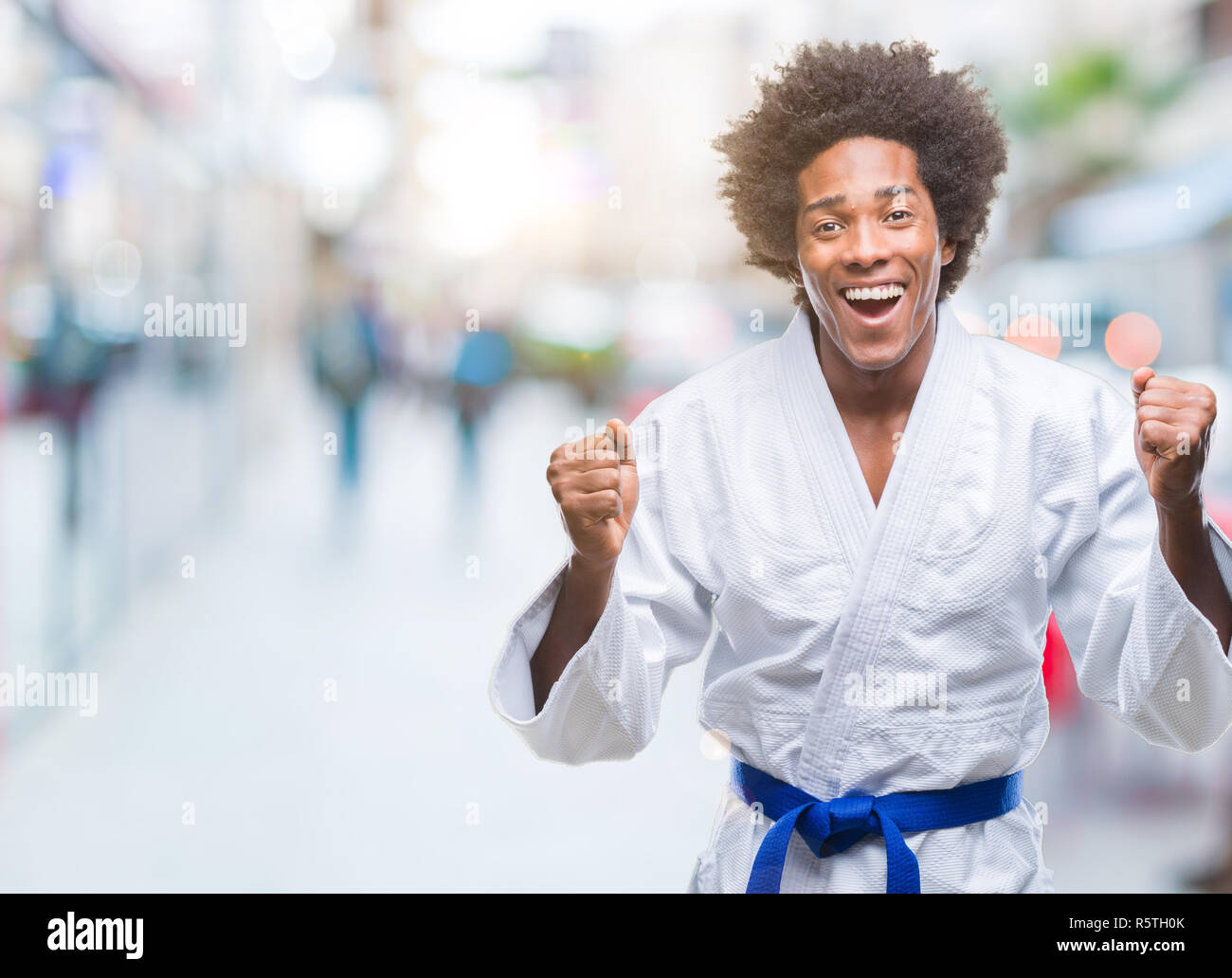 Afro american man wearing karate kimono over isolated background ...