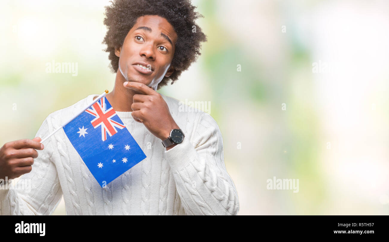 Afro american man flag of Australia over isolated background serious ...