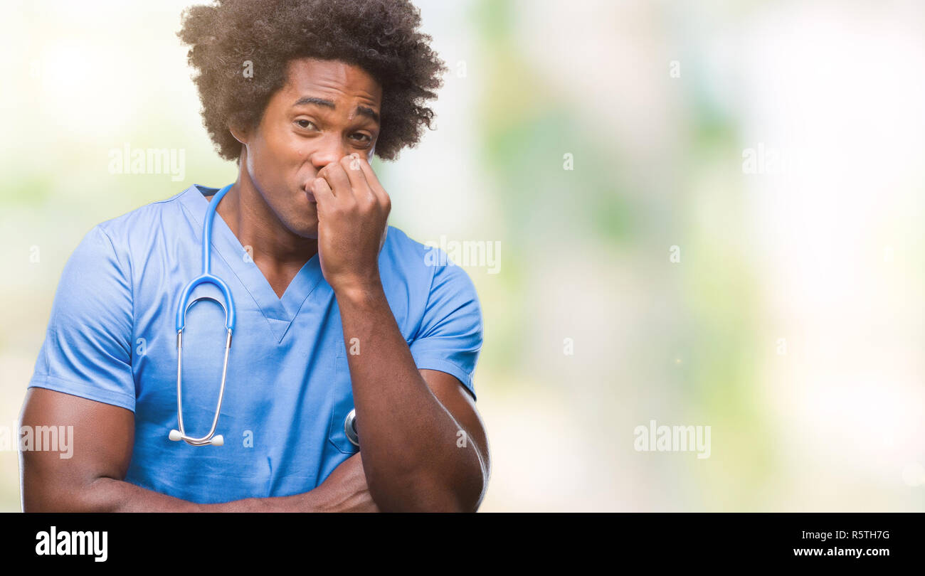 Afro american surgeon doctor man over isolated background looking ...