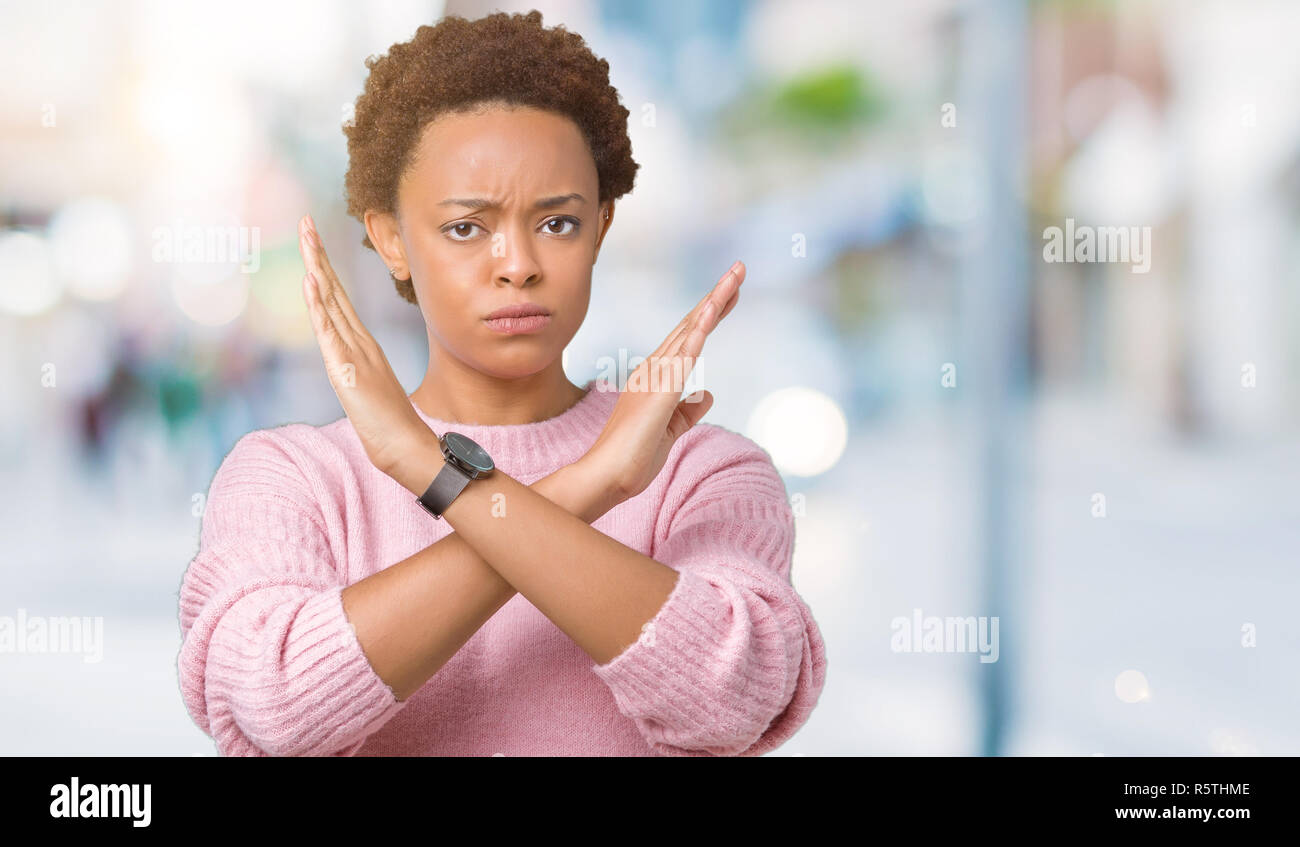 Beautiful young african american woman over isolated background ...