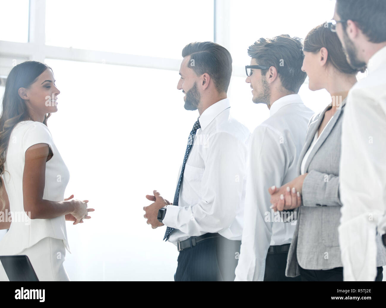 business team looks out the office window Stock Photo - Alamy