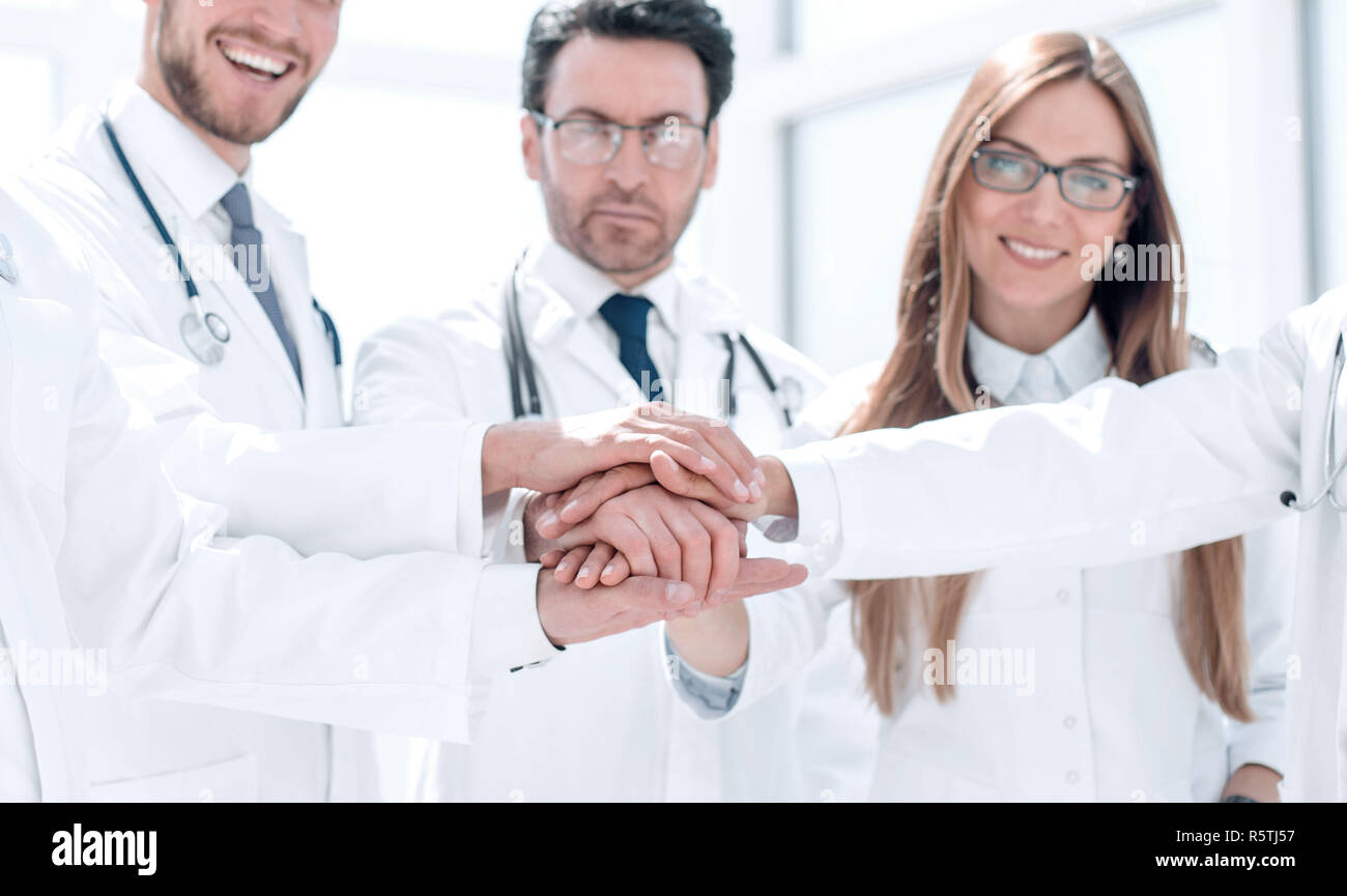 group of doctors with their hands folded together Stock Photo - Alamy