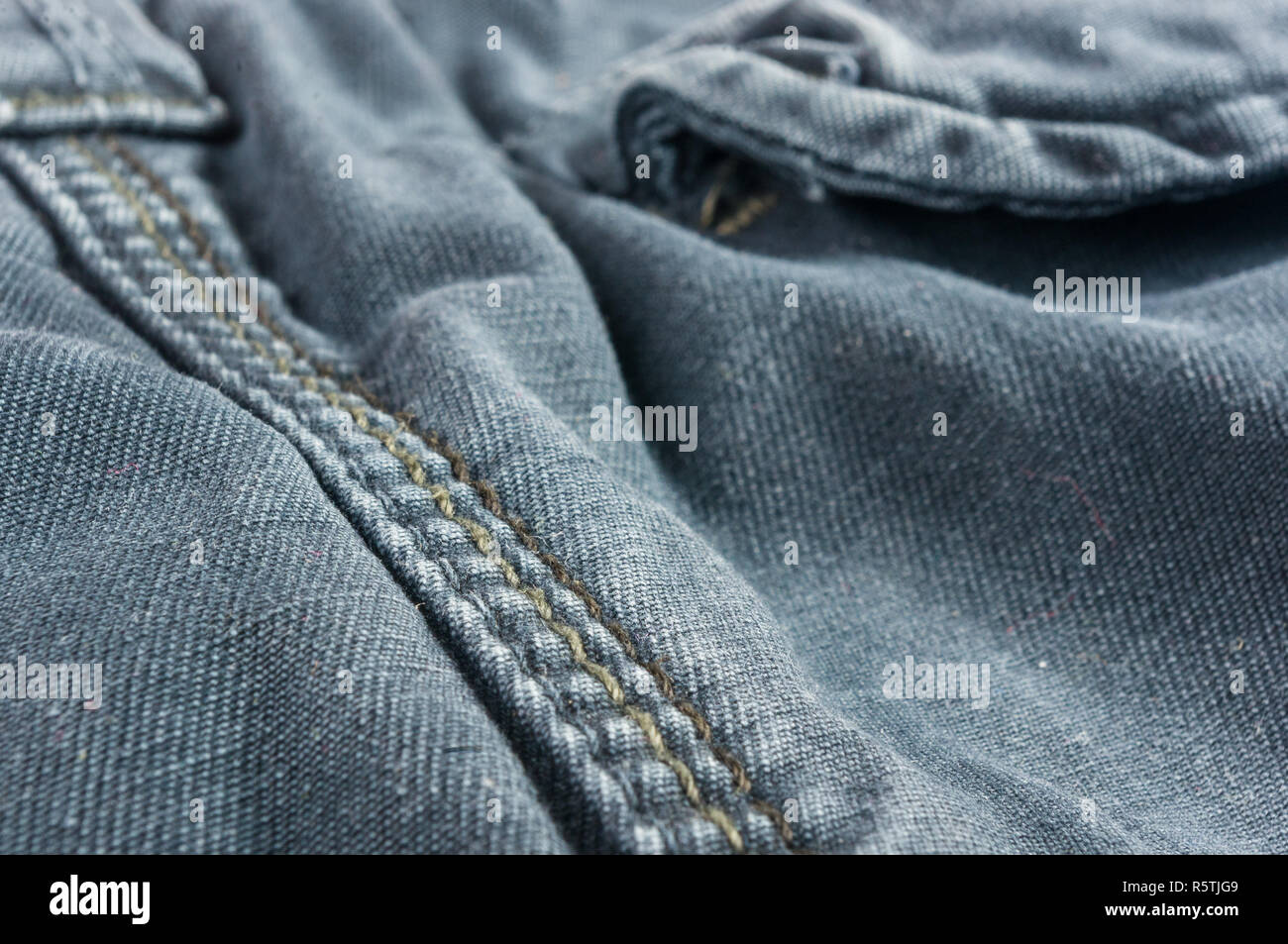 clothing items washed cotton fabric texture with seams, macro, close-up ...