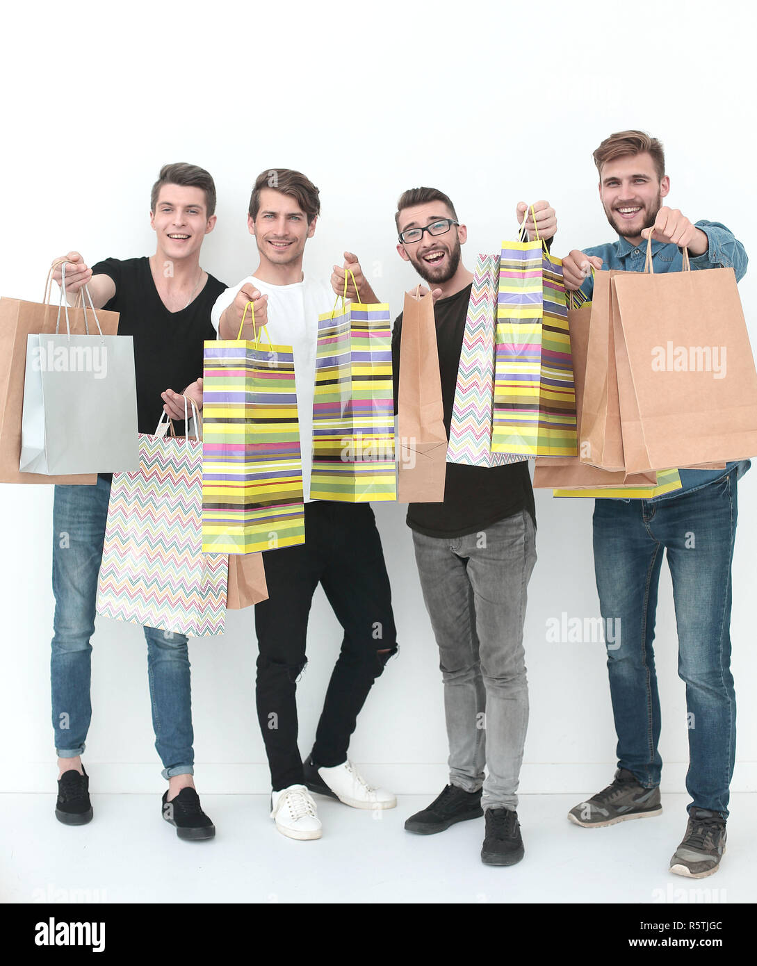 group of young men shows shopping bags Stock Photo - Alamy