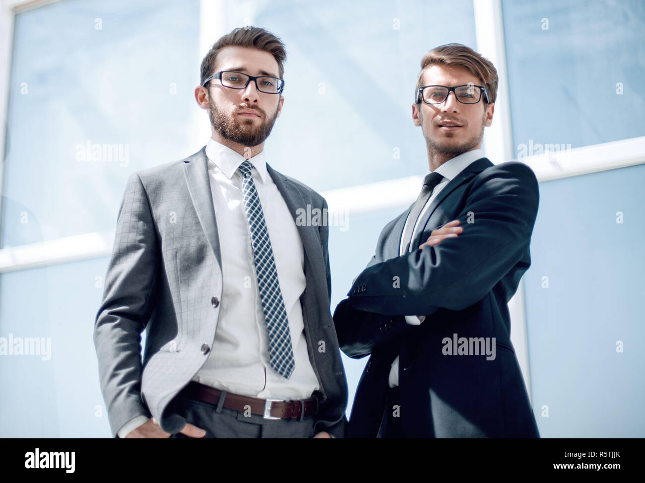two business partners standing near the office window Stock Photo - Alamy
